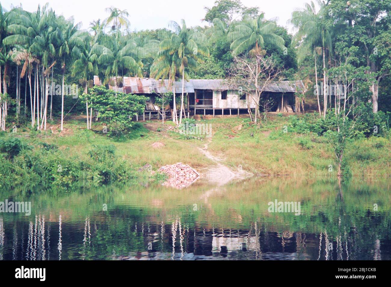 A log shack far from civilization in the Amazon rainforest in the 1980s ...
