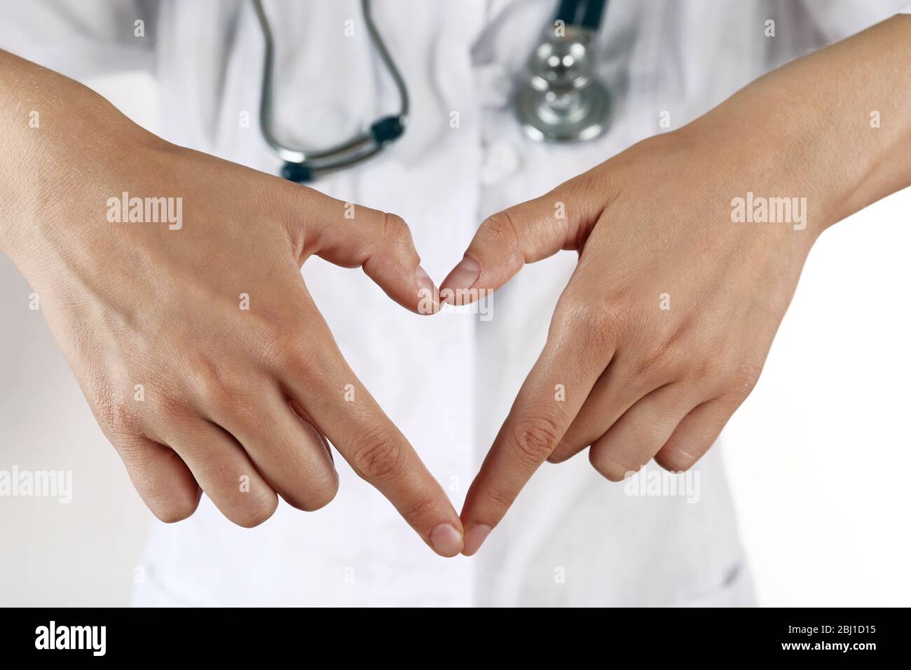 Doctor's hands making heart shape close up Stock Photo - Alamy