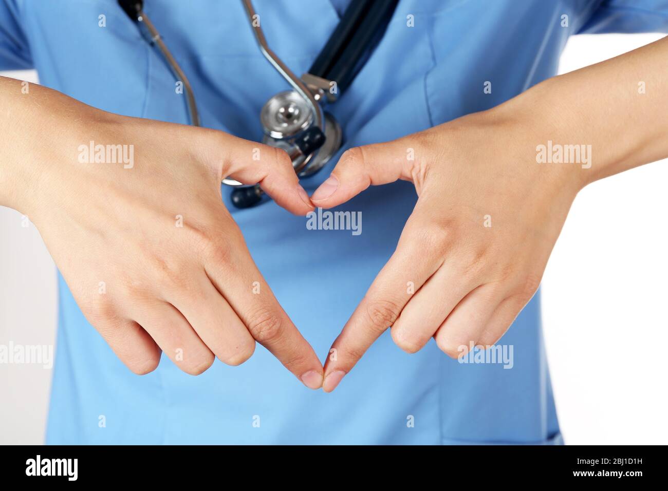 Doctor's hands making heart shape close up Stock Photo - Alamy