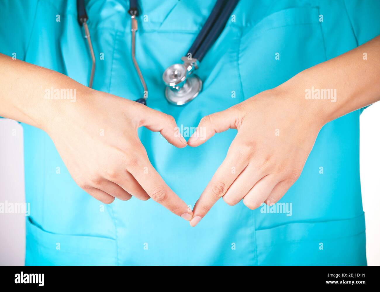 Doctor's hands making heart shape close up Stock Photo - Alamy