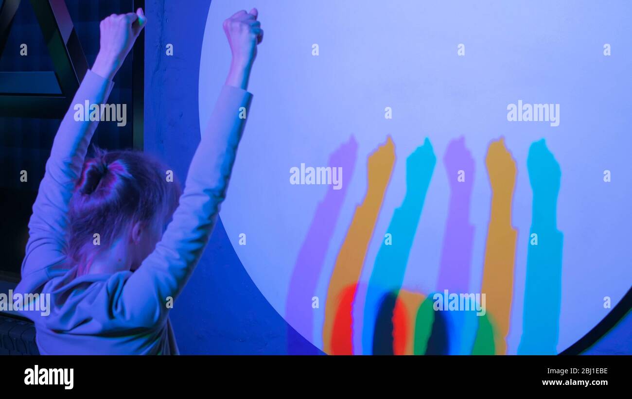 Interactive exposition in science museum. Colored shadows of dancing ...