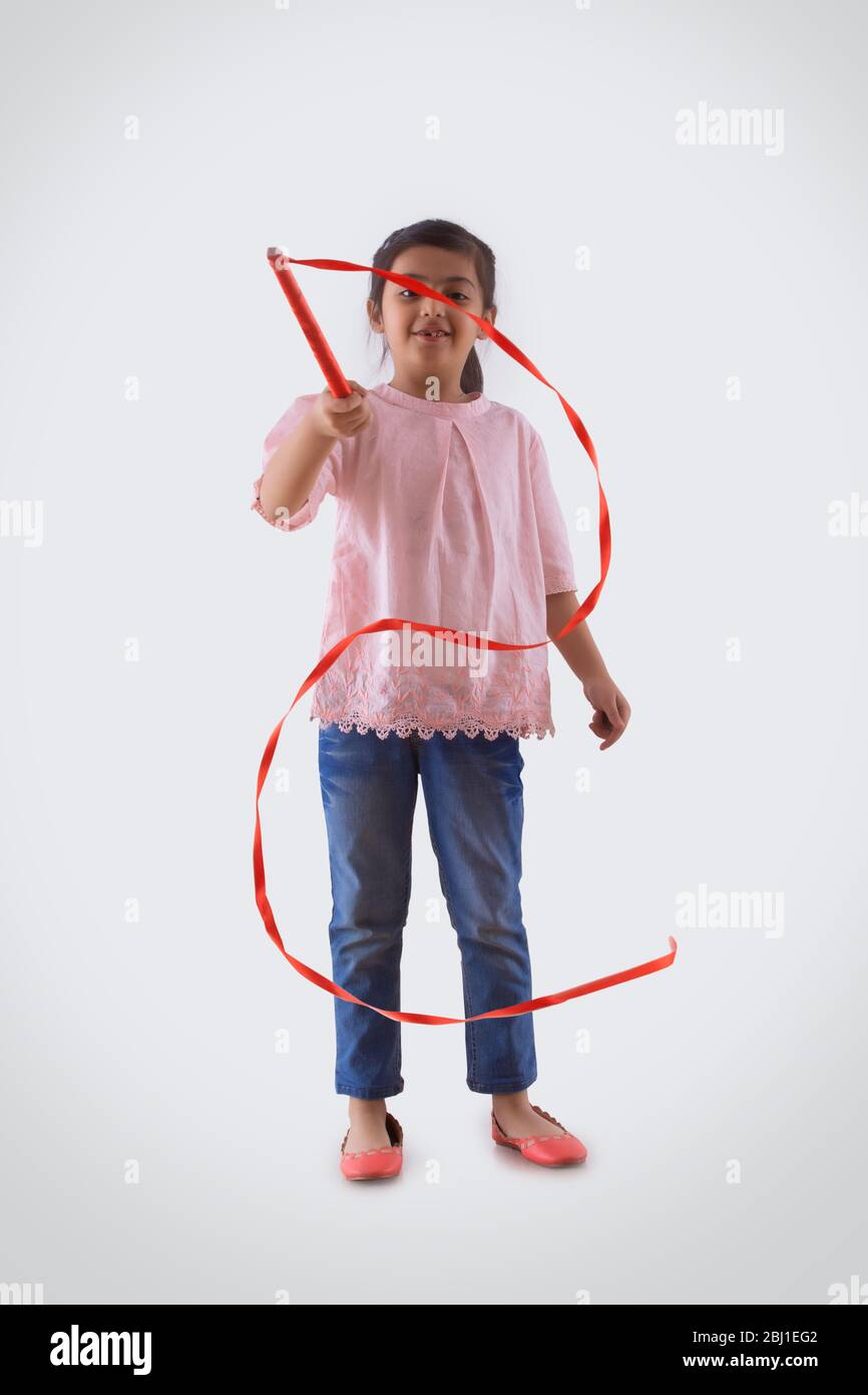 young girl playing with a ribbon wand Stock Photo - Alamy