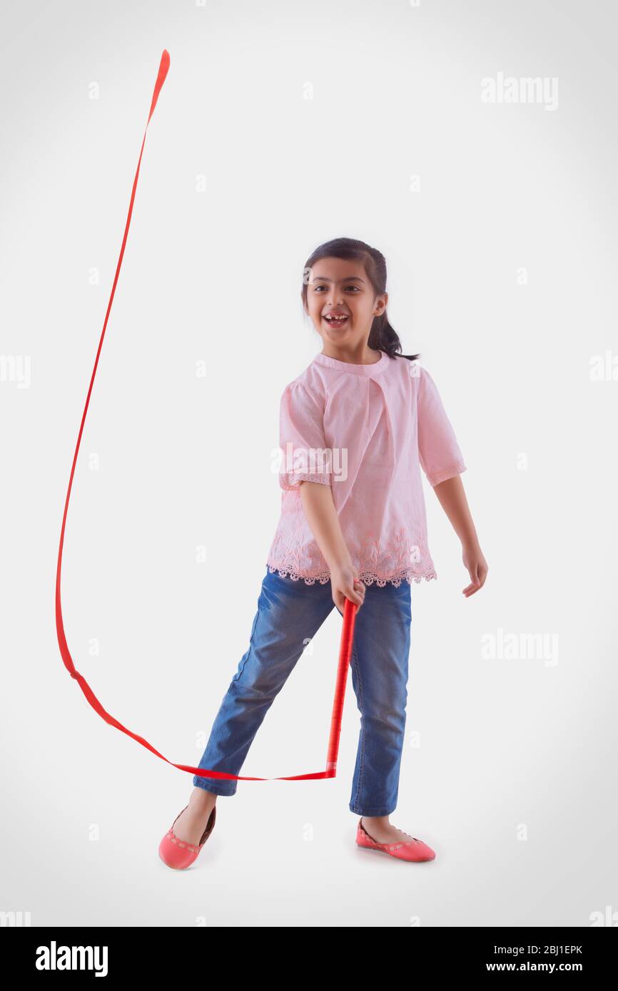 young girl playing with a ribbon wand Stock Photo - Alamy