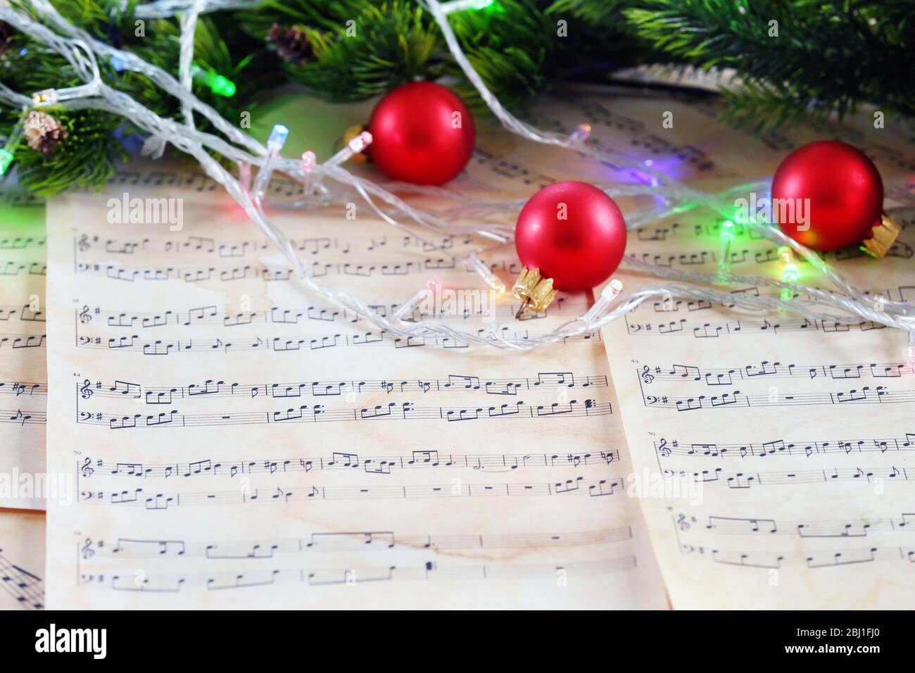 Christmas decorations on music sheets, closeup Stock Photo - Alamy