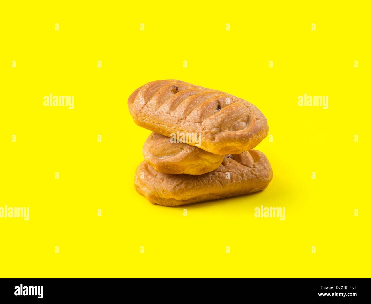 Bakery sweet pastry stack on yellow background Stock Photo - Alamy
