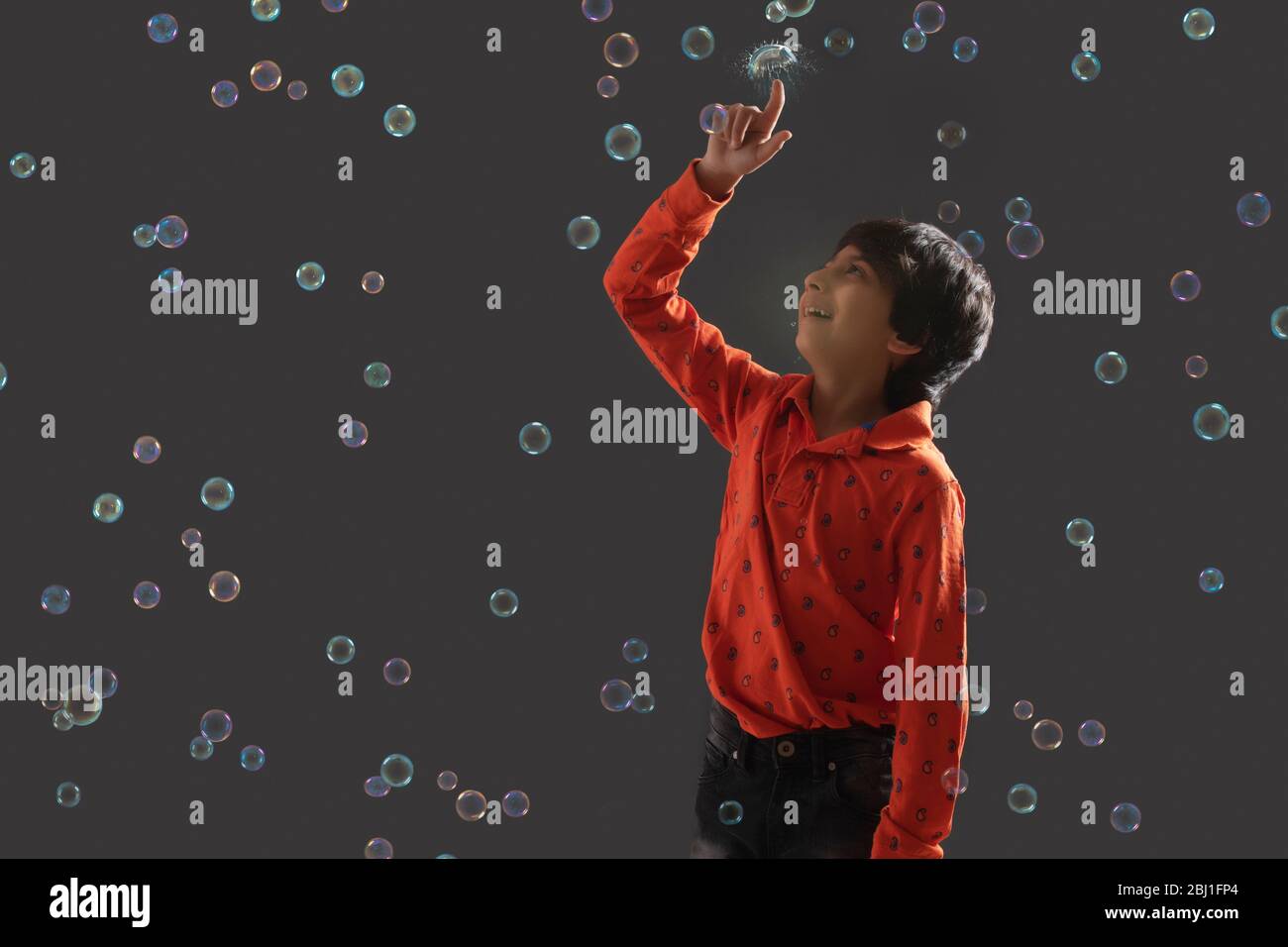 portrait of a young boy popping a bubble Stock Photo - Alamy