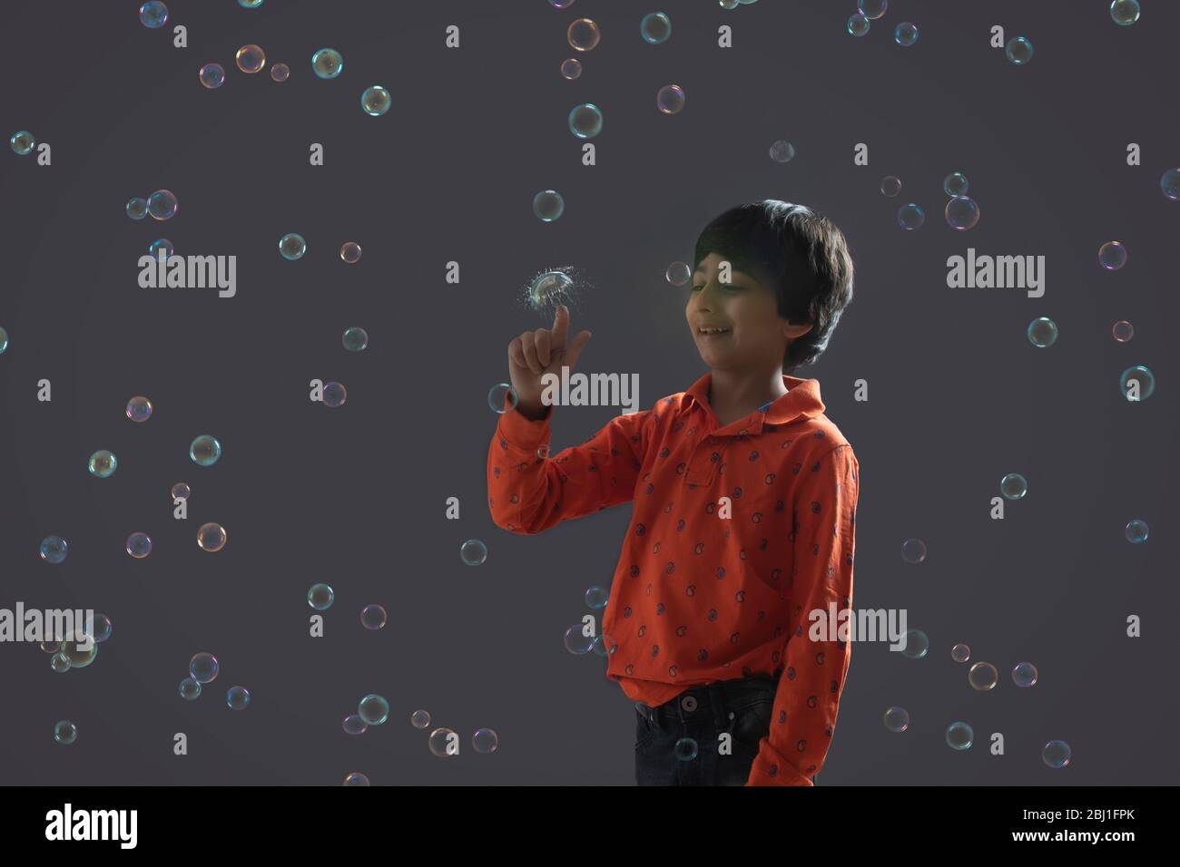 portrait of a young boy popping a bubble Stock Photo - Alamy