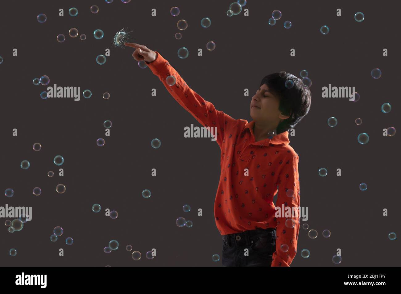 portrait of a young boy popping a bubble Stock Photo - Alamy