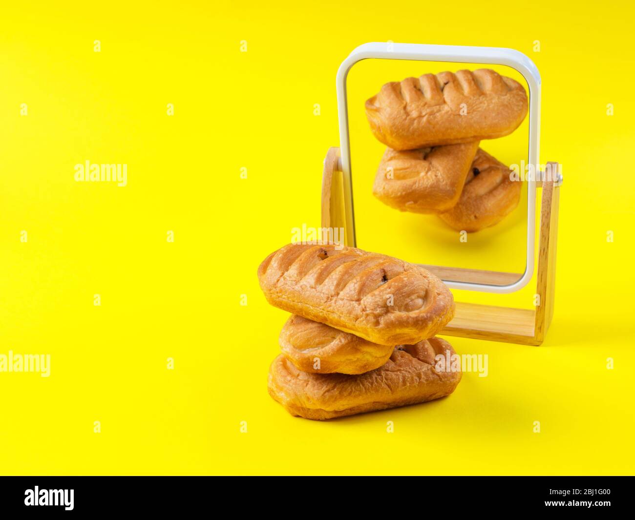 Bakery sweet pastry stack reflected in mirror Stock Photo - Alamy