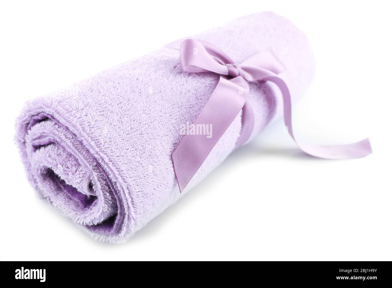 Rolled up colorful towel isolated on white Stock Photo - Alamy