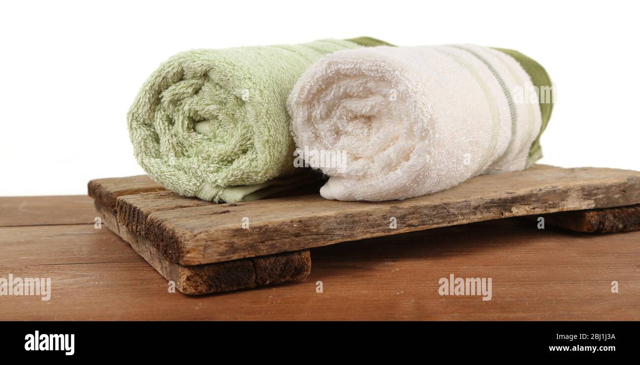 Rolled bath towels on wooden table, closeup Stock Photo - Alamy