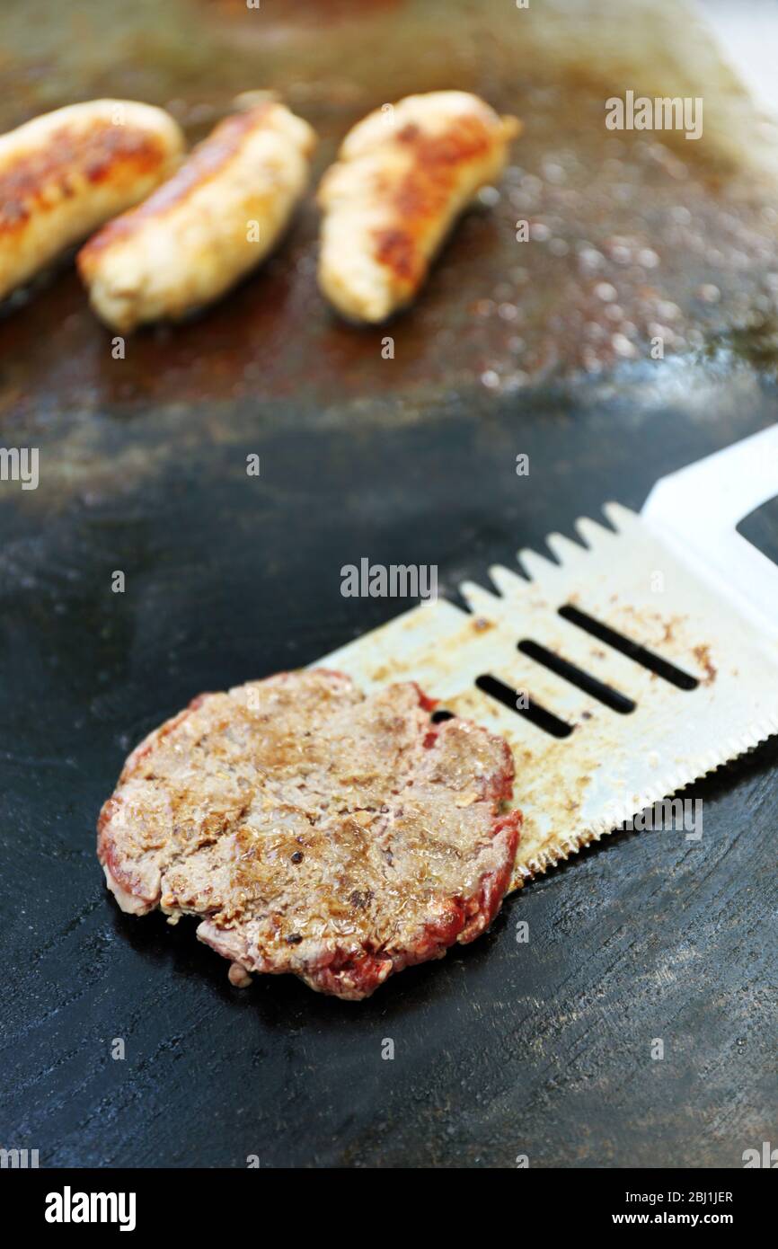 Burgers cooking in frying pan close up Stock Photo - Alamy