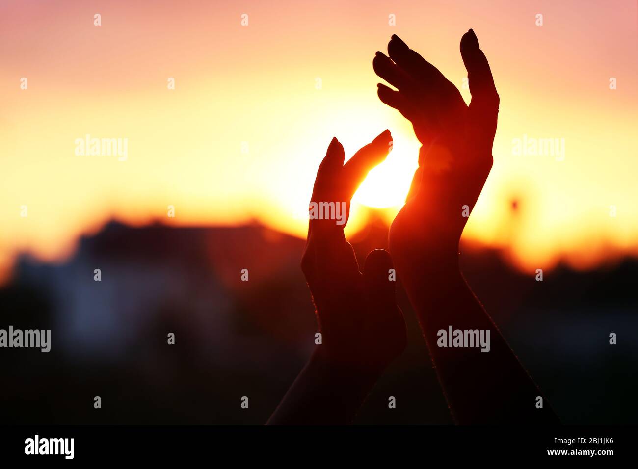 Female hands on sunset background Stock Photo - Alamy