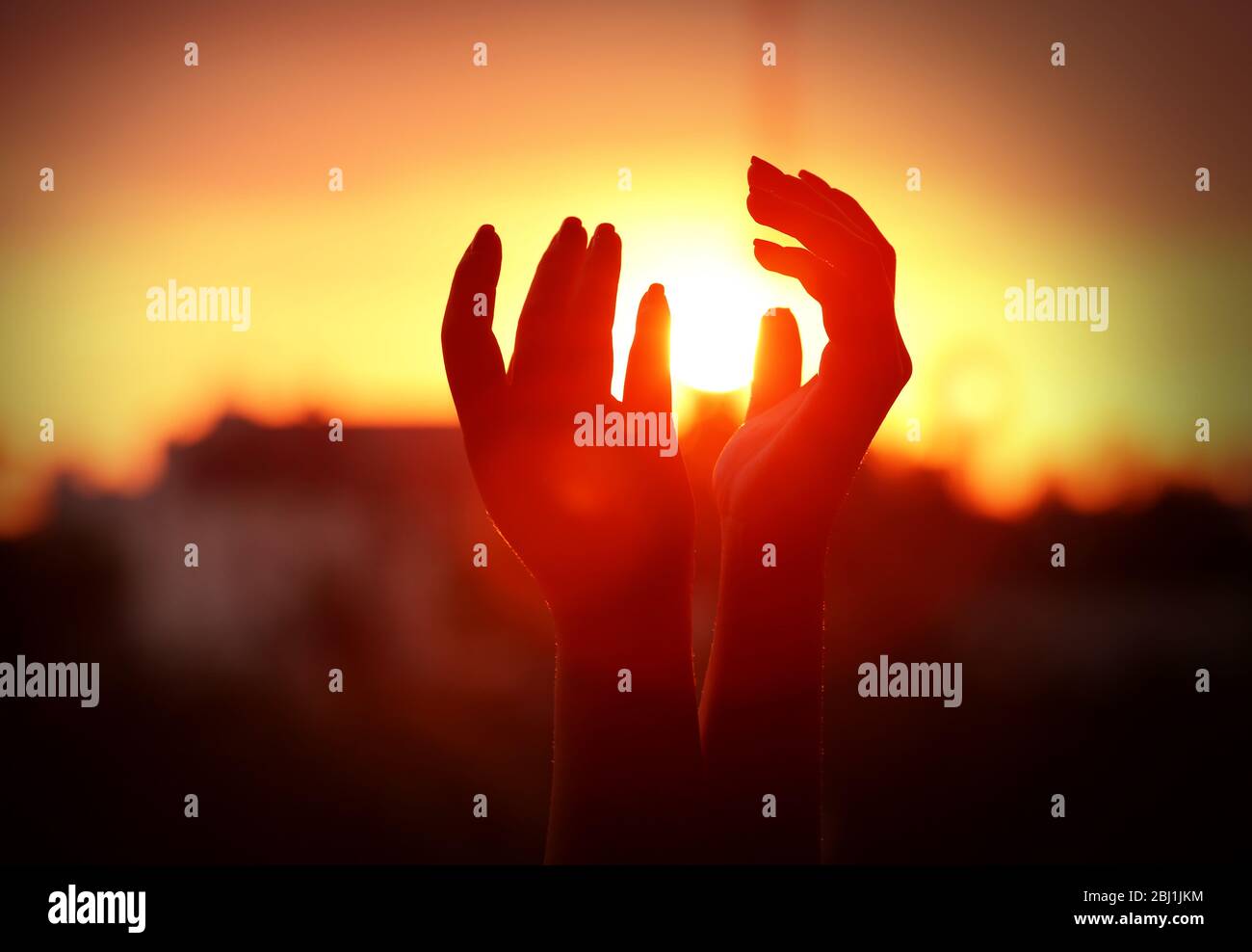 Female hands on sunset background Stock Photo - Alamy