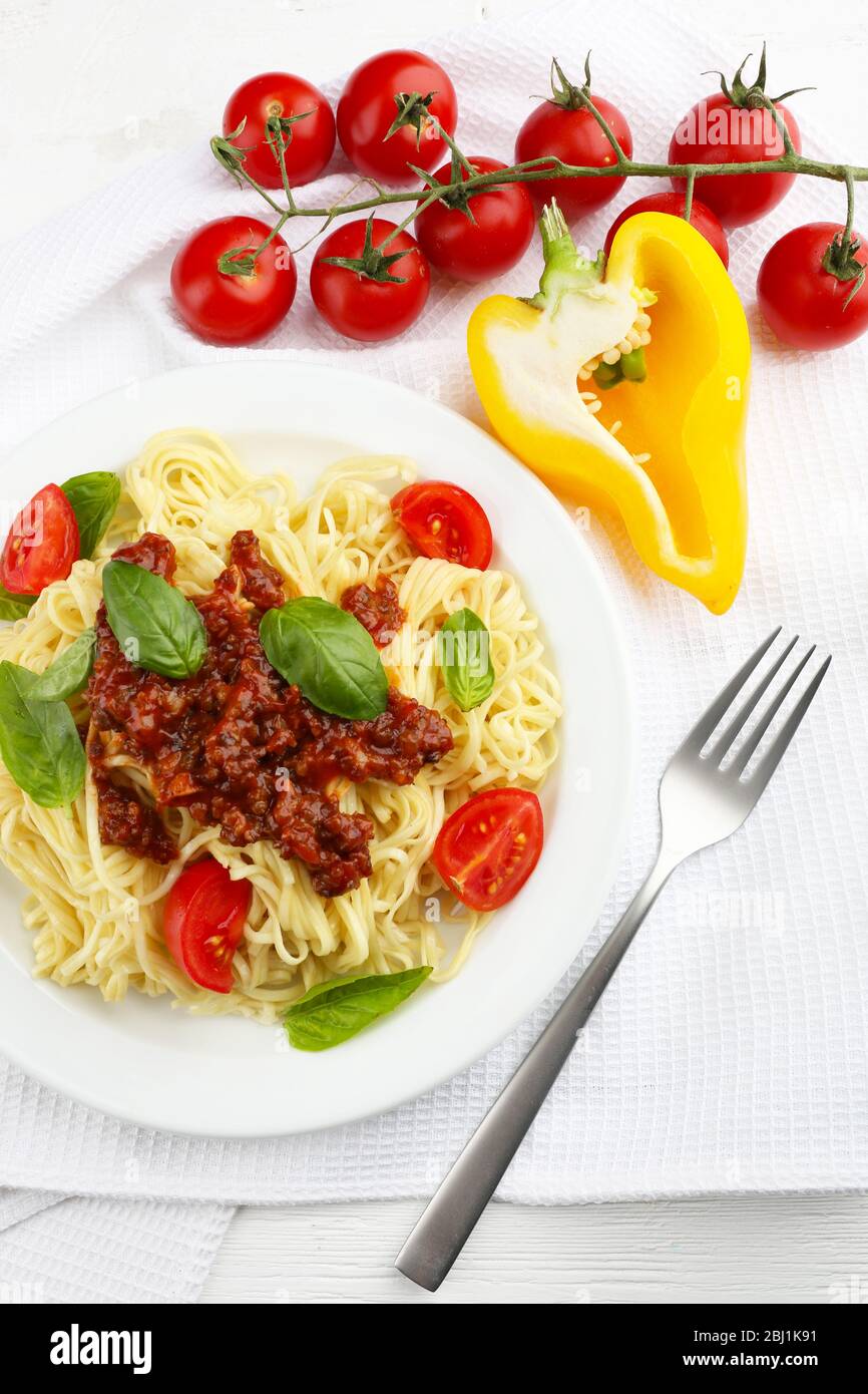 Spaghetti Bolognese on white plate, on color wooden background Stock ...