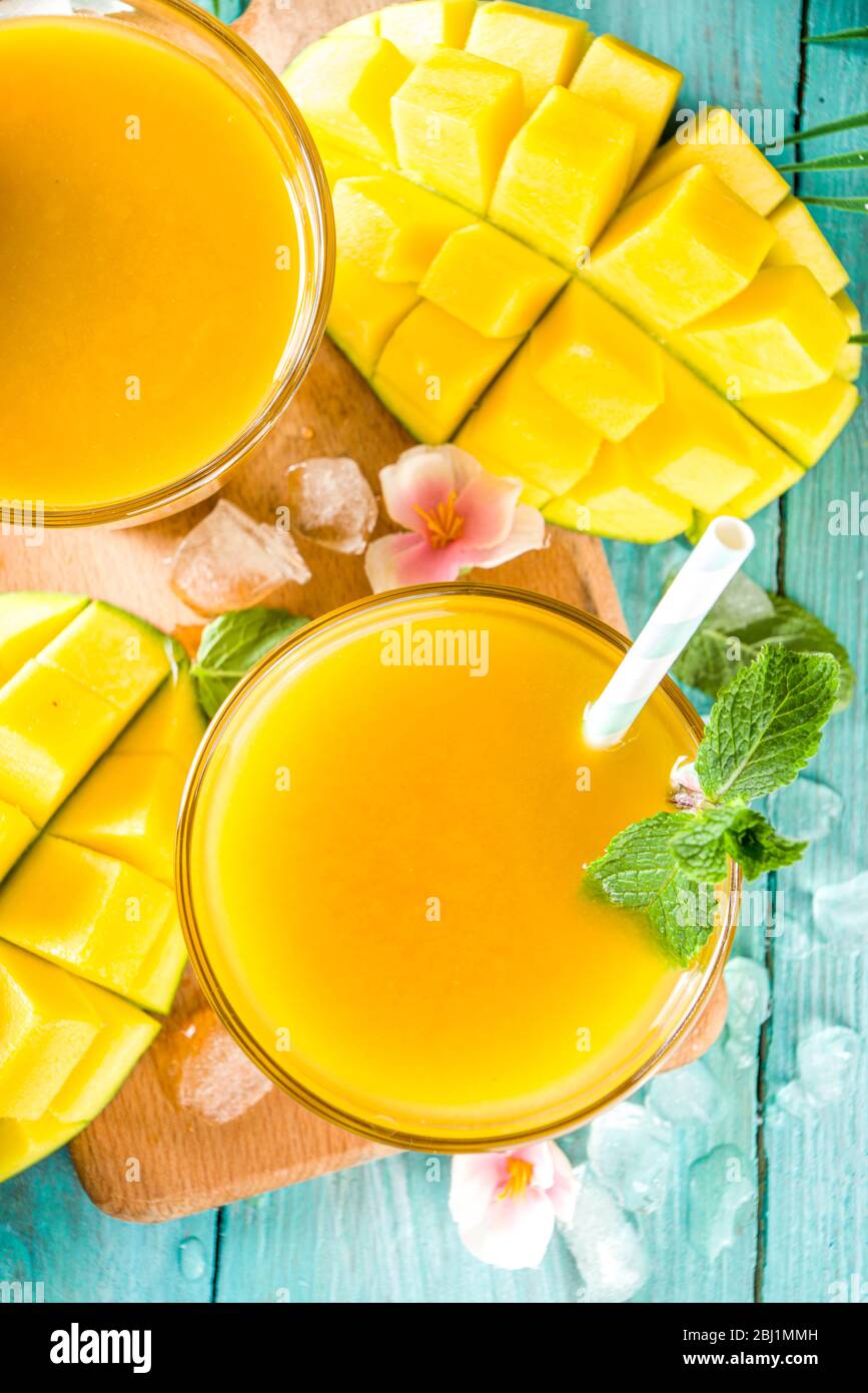 Fresh summer tropical fruit drink. Mango smoothie or mango juice, with ...