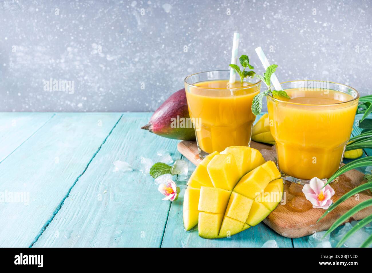 Fresh summer tropical fruit drink. Mango smoothie or mango juice, with ...