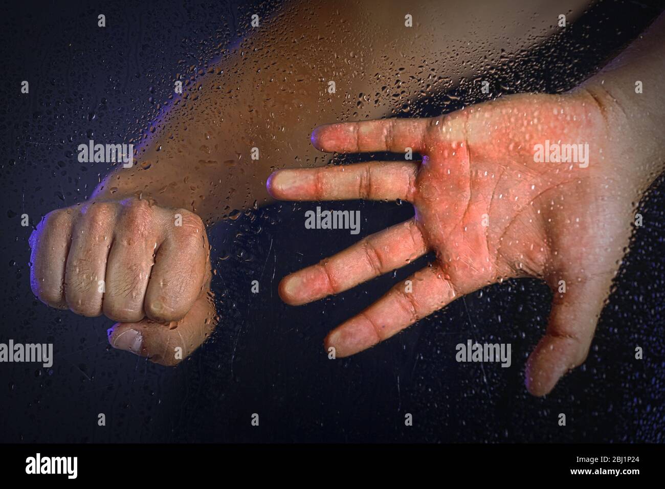 Male hands behind wet glass, close-up Stock Photo - Alamy