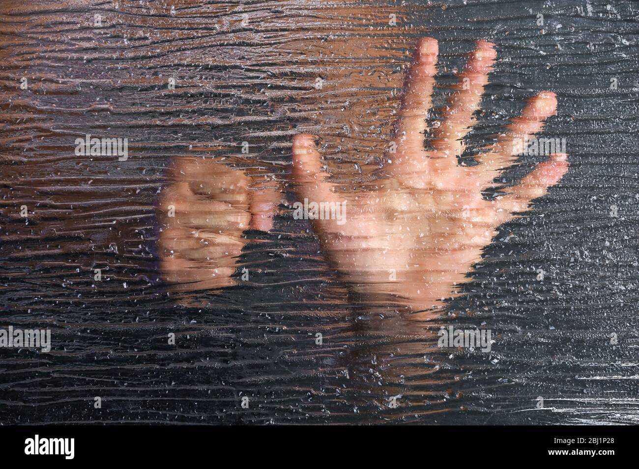 Male hand behind frosted glass, close-up Stock Photo - Alamy