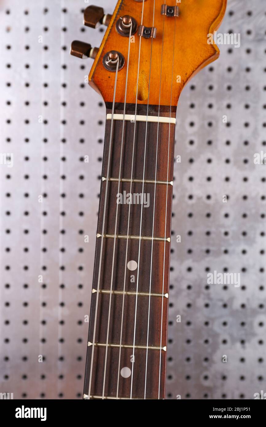 Guitar strings on metal grid background Stock Photo - Alamy