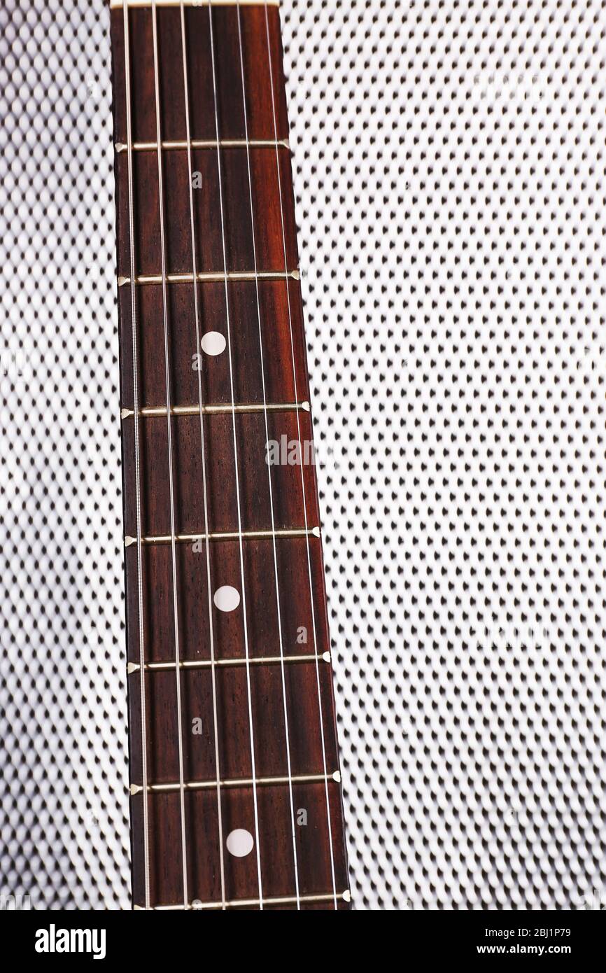 Guitar strings on metal grid background Stock Photo - Alamy
