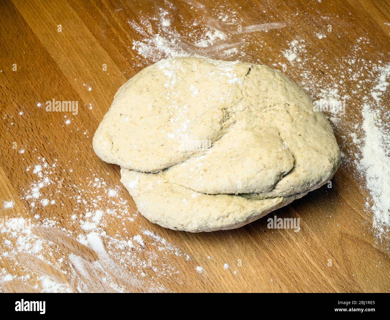 Oat bread dough on a floured kitchen table ready for kneading Stock ...