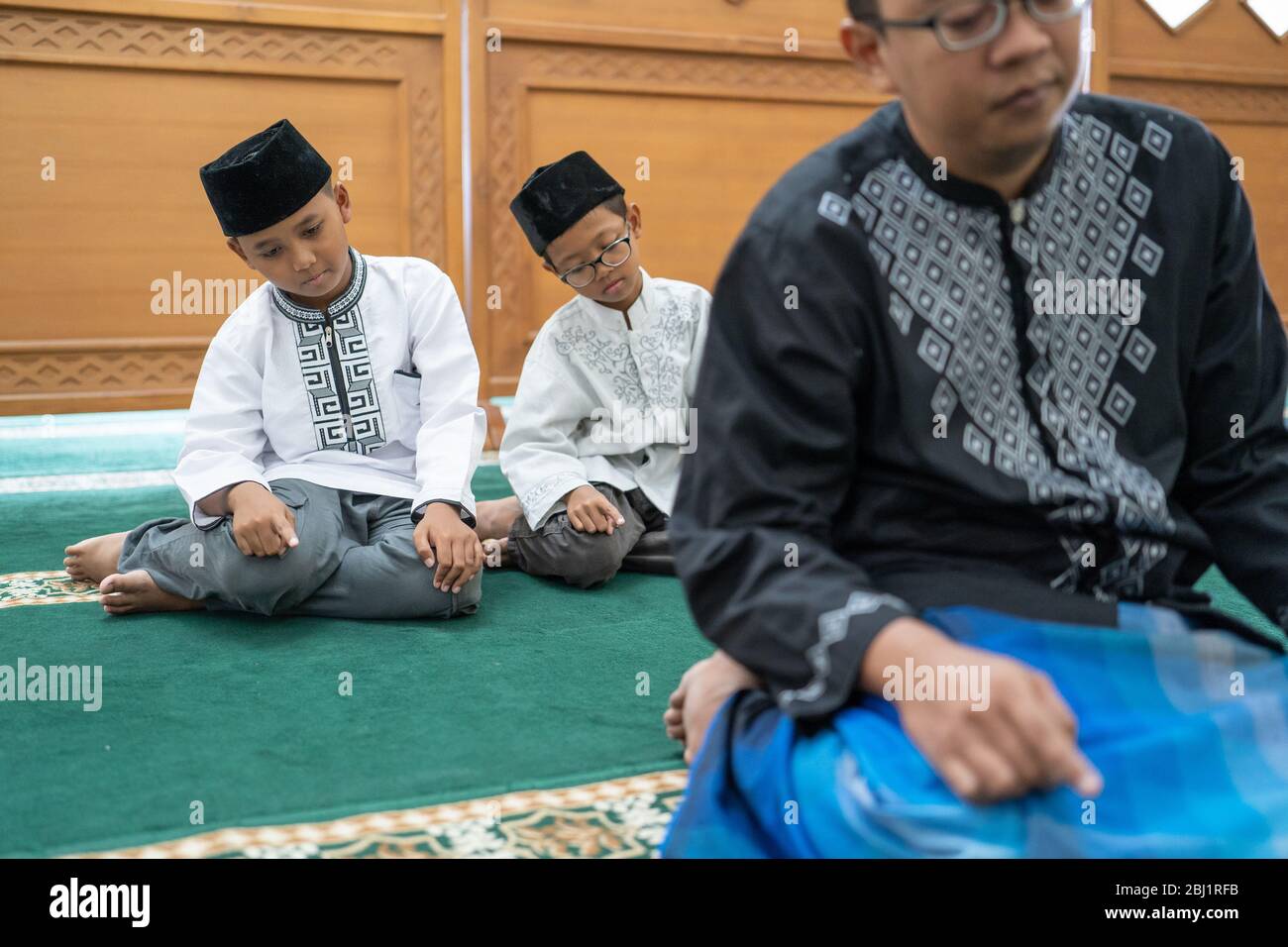 of muslim family praying in the mosque. muslim parenting Stock Photo ...
