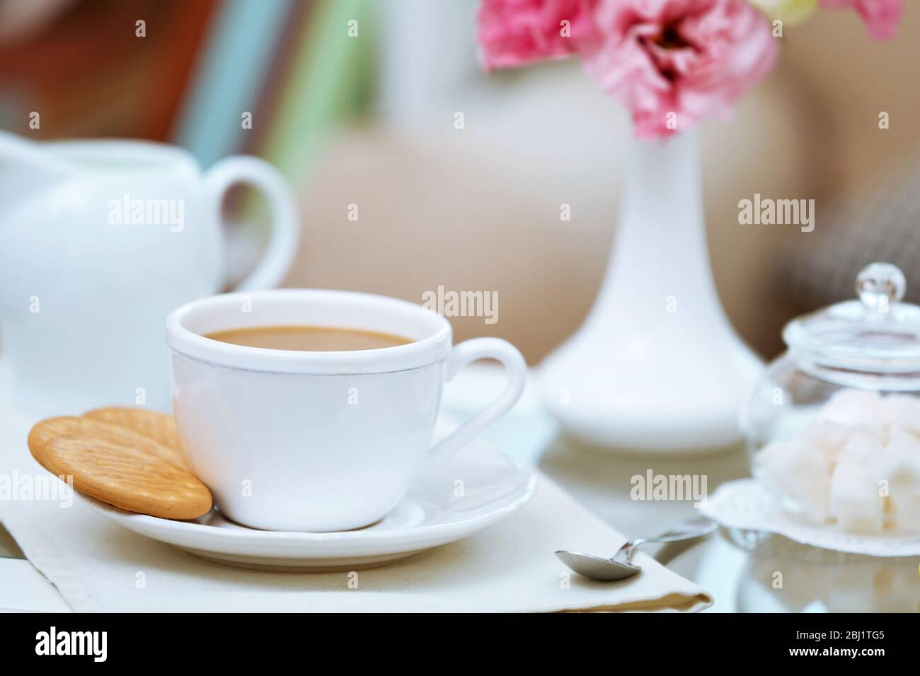 Cup of coffee on table in living room Stock Photo - Alamy