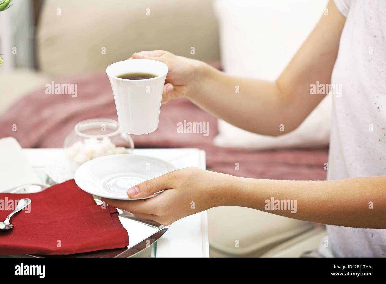 Female hand holding cup of tea in living room Stock Photo - Alamy