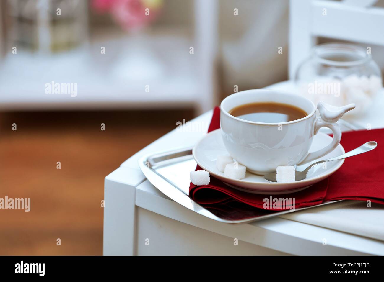 Cup of tea on chair in room Stock Photo - Alamy