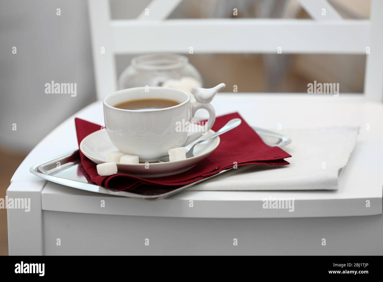 Cup of tea on chair in room Stock Photo - Alamy