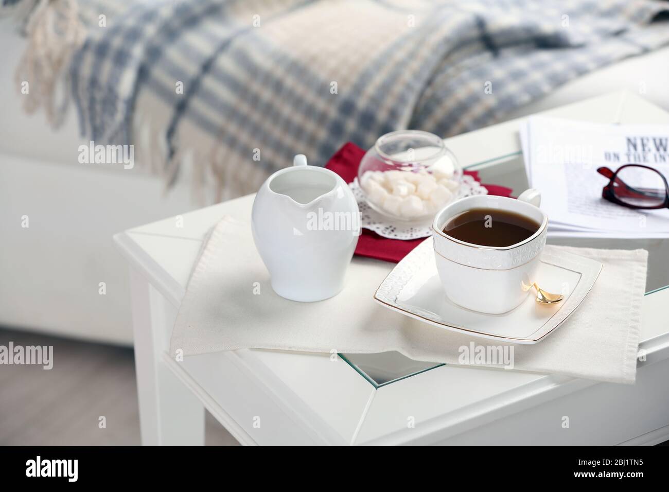 Cup of tea on table in living room Stock Photo - Alamy