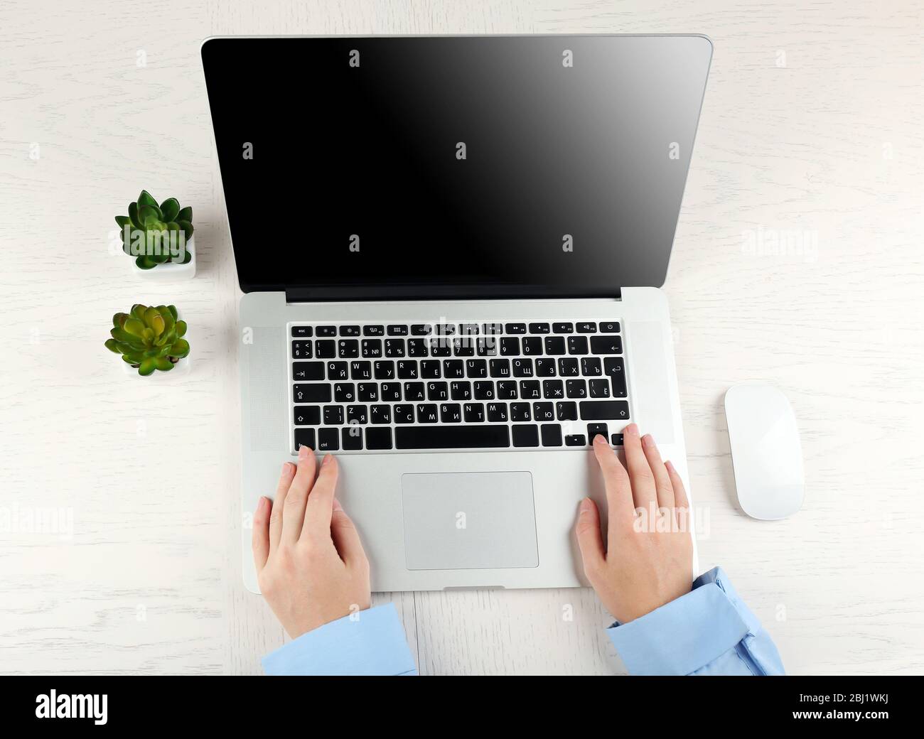 Hands working in the office with laptop on white table Stock Photo - Alamy