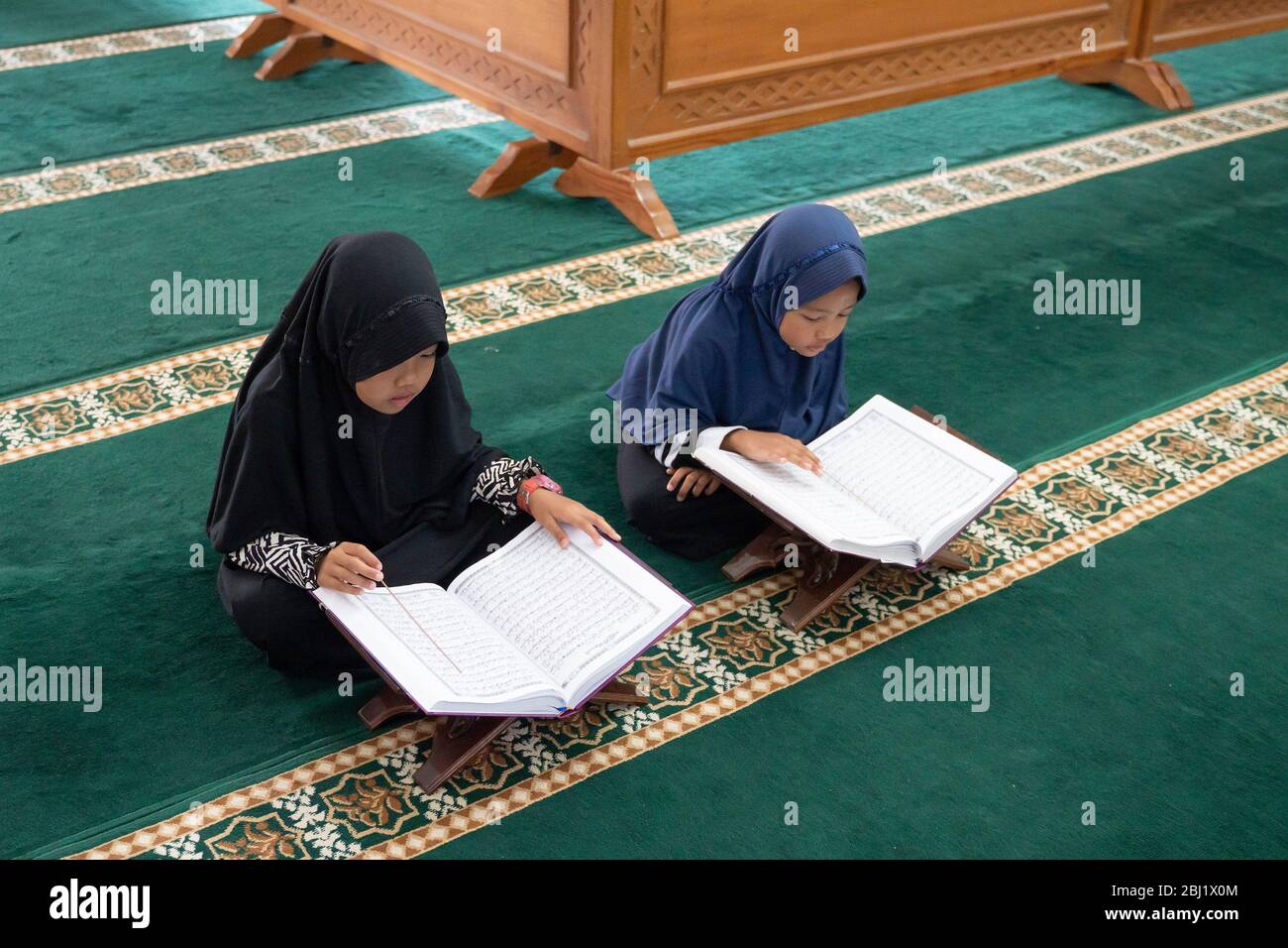 two kids read holy quran together in the mosque Stock Photo - Alamy