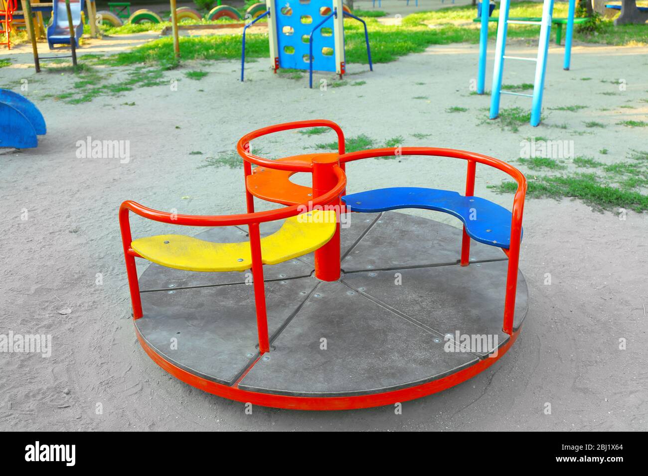 Children carousel on playground in park Stock Photo - Alamy