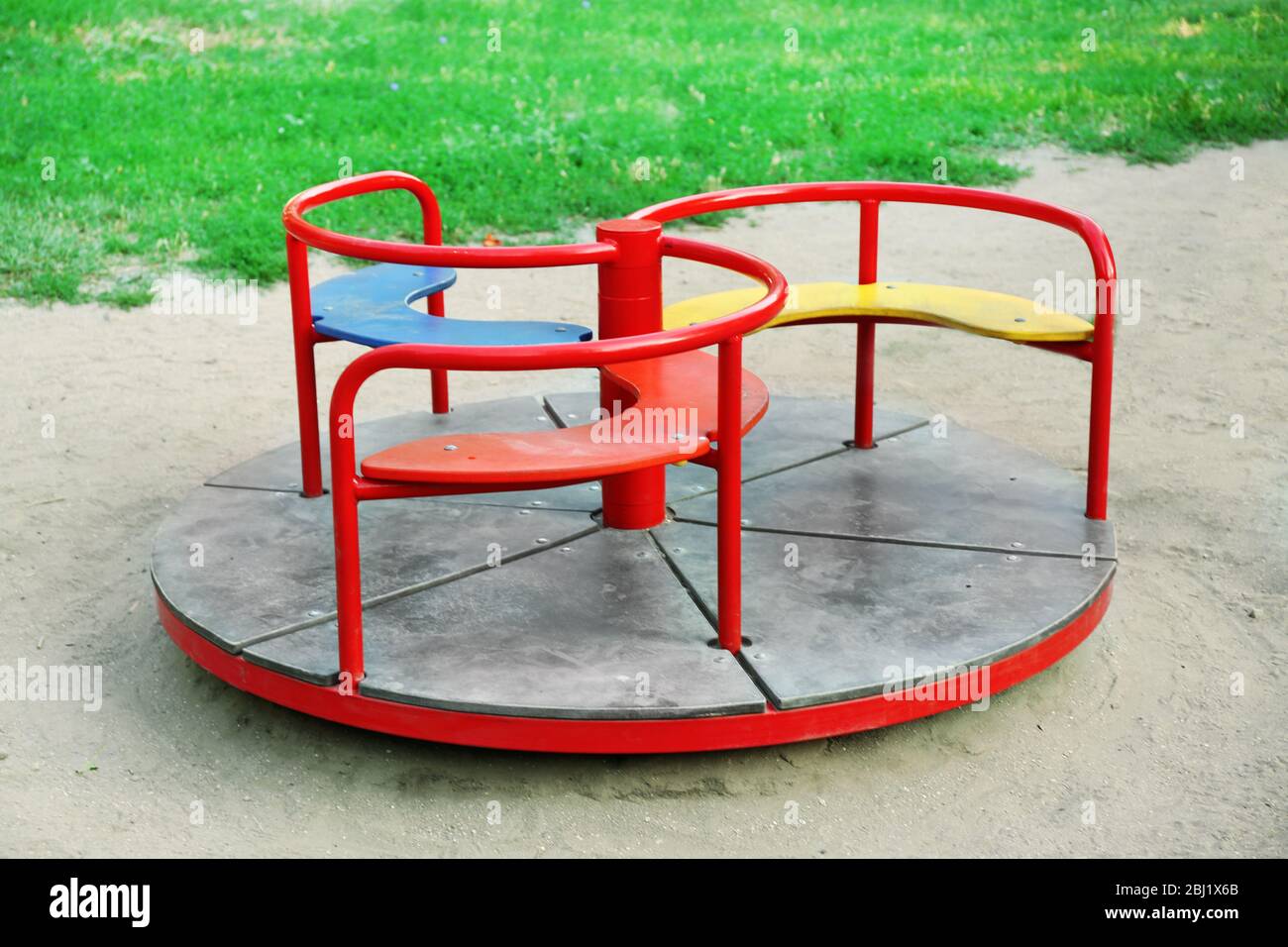 Children carousel on playground in park Stock Photo - Alamy