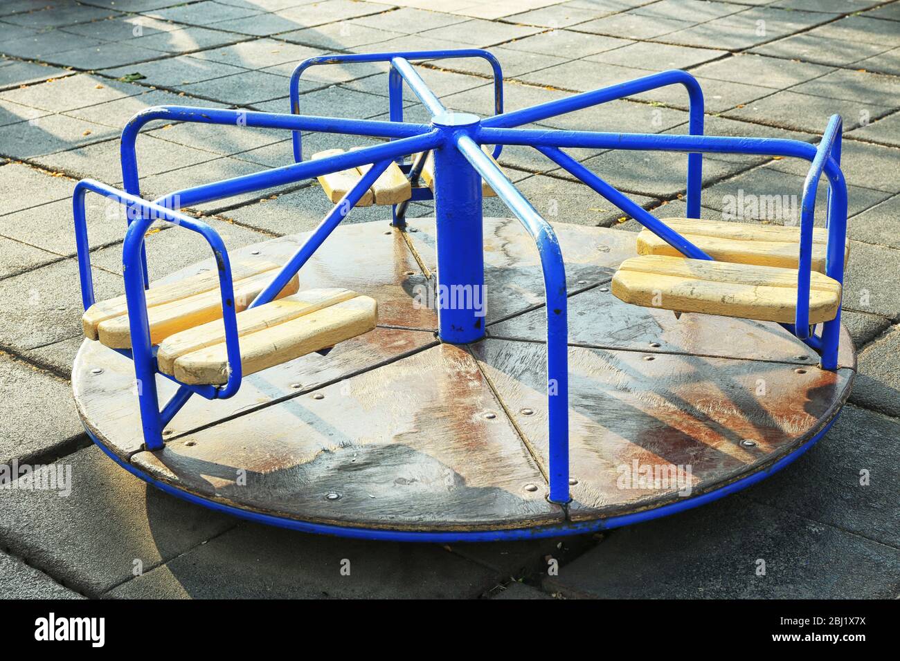 Children carousel on playground in park Stock Photo - Alamy