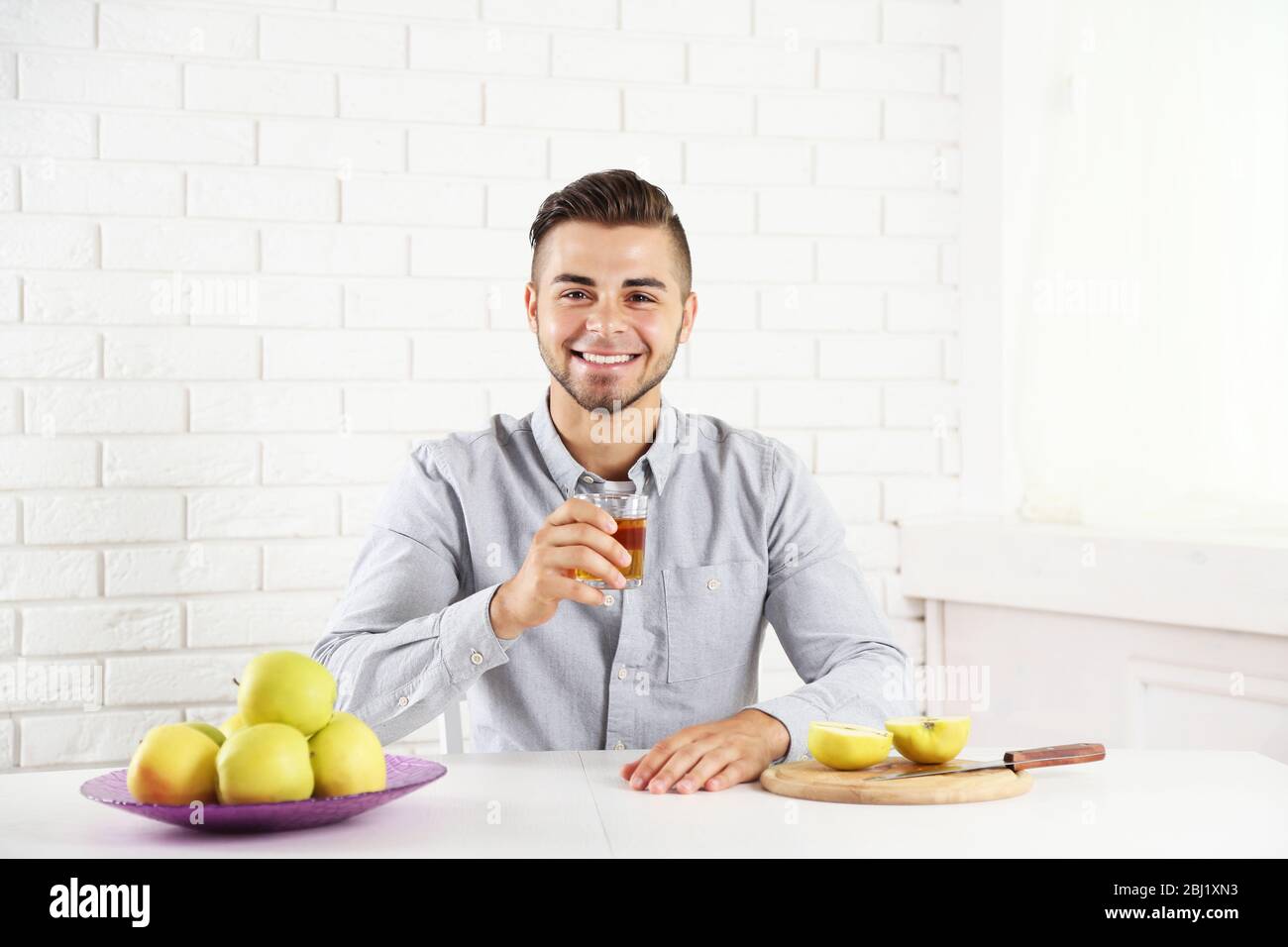 Man drinking glass apple juice hi-res stock photography and images - Alamy