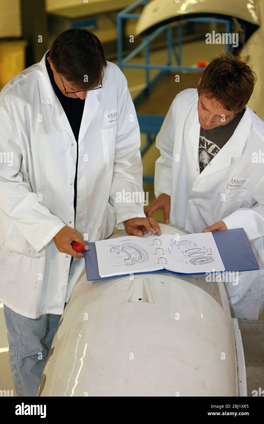 Engineering students working on jet engine Stock Photo - Alamy
