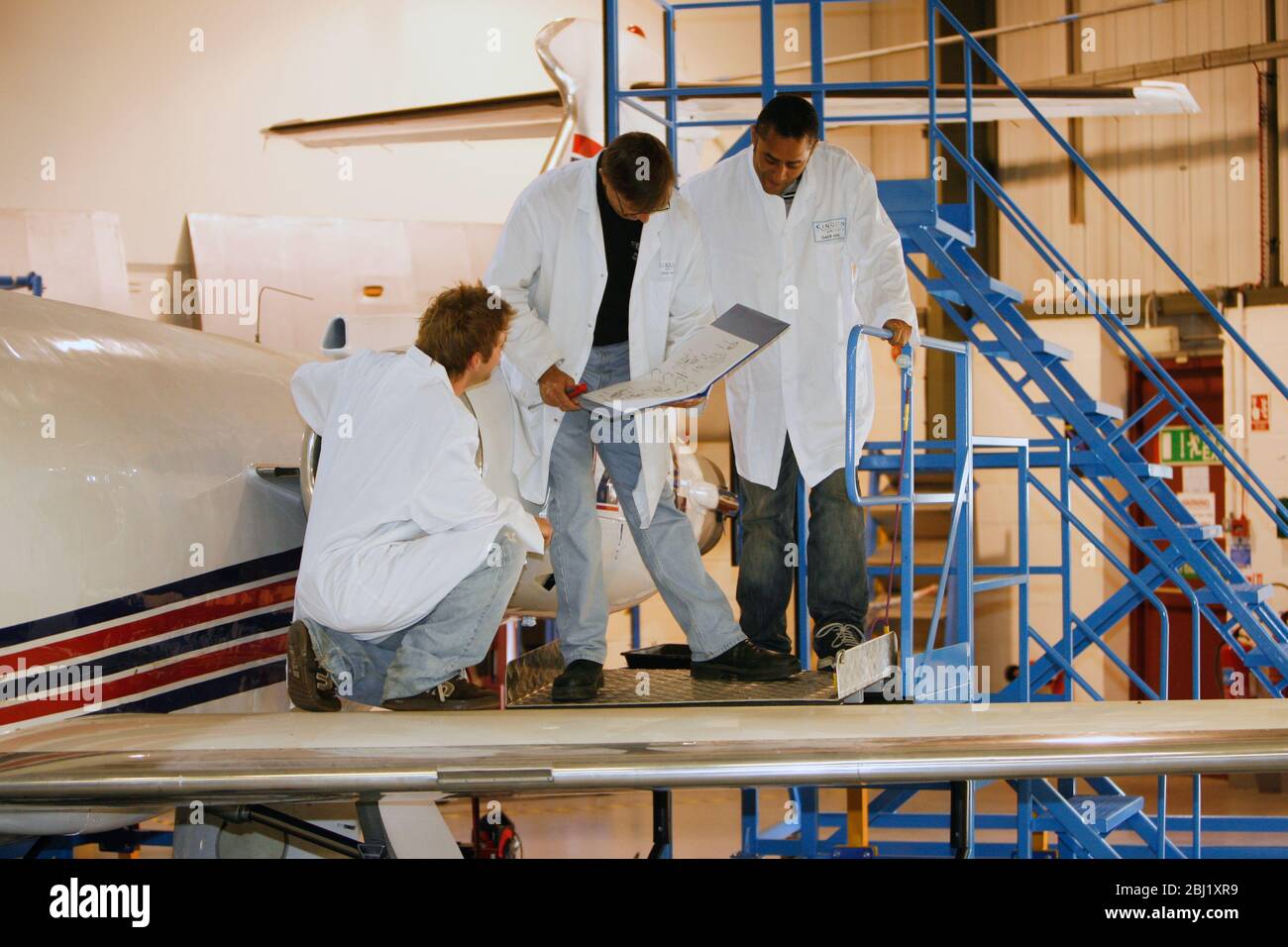 Engineering students working on jet engine Stock Photo - Alamy