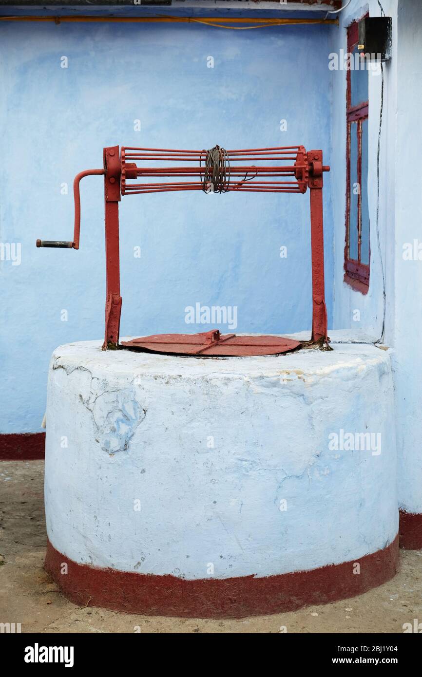 Rural water well on white wall background Stock Photo - Alamy