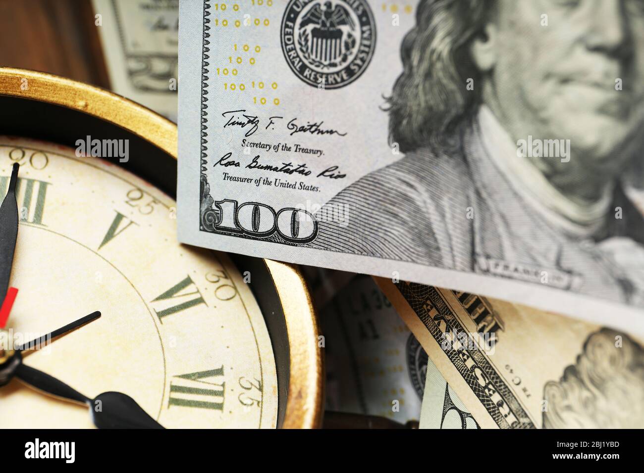 Money and alarm clock, closeup Stock Photo - Alamy
