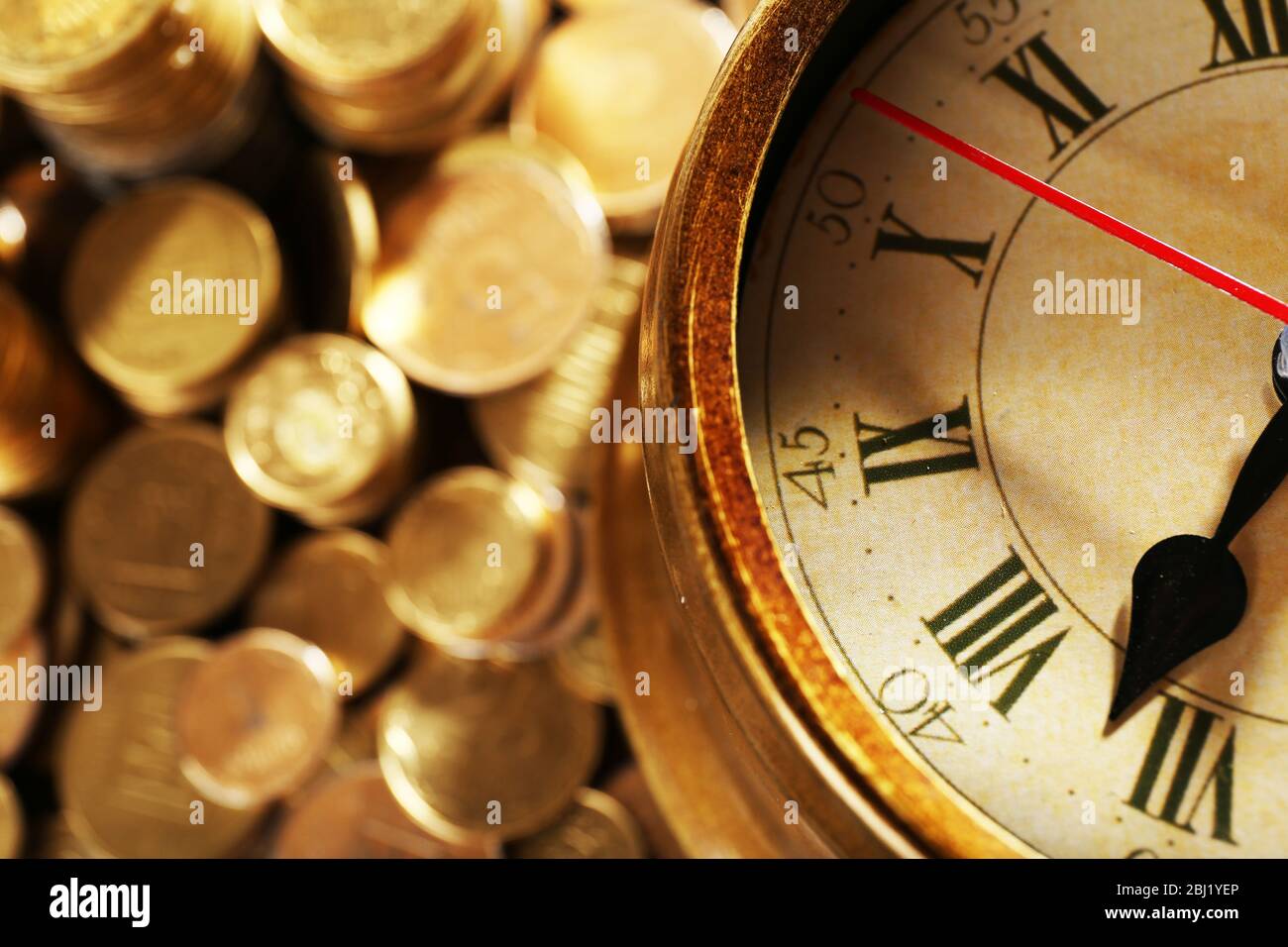 Money and alarm clock, closeup Stock Photo - Alamy