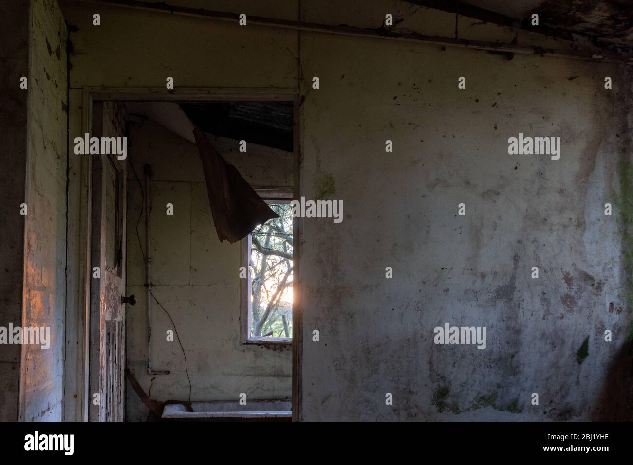 A spooky ruined, abandoned house. With sun light coming through a ...