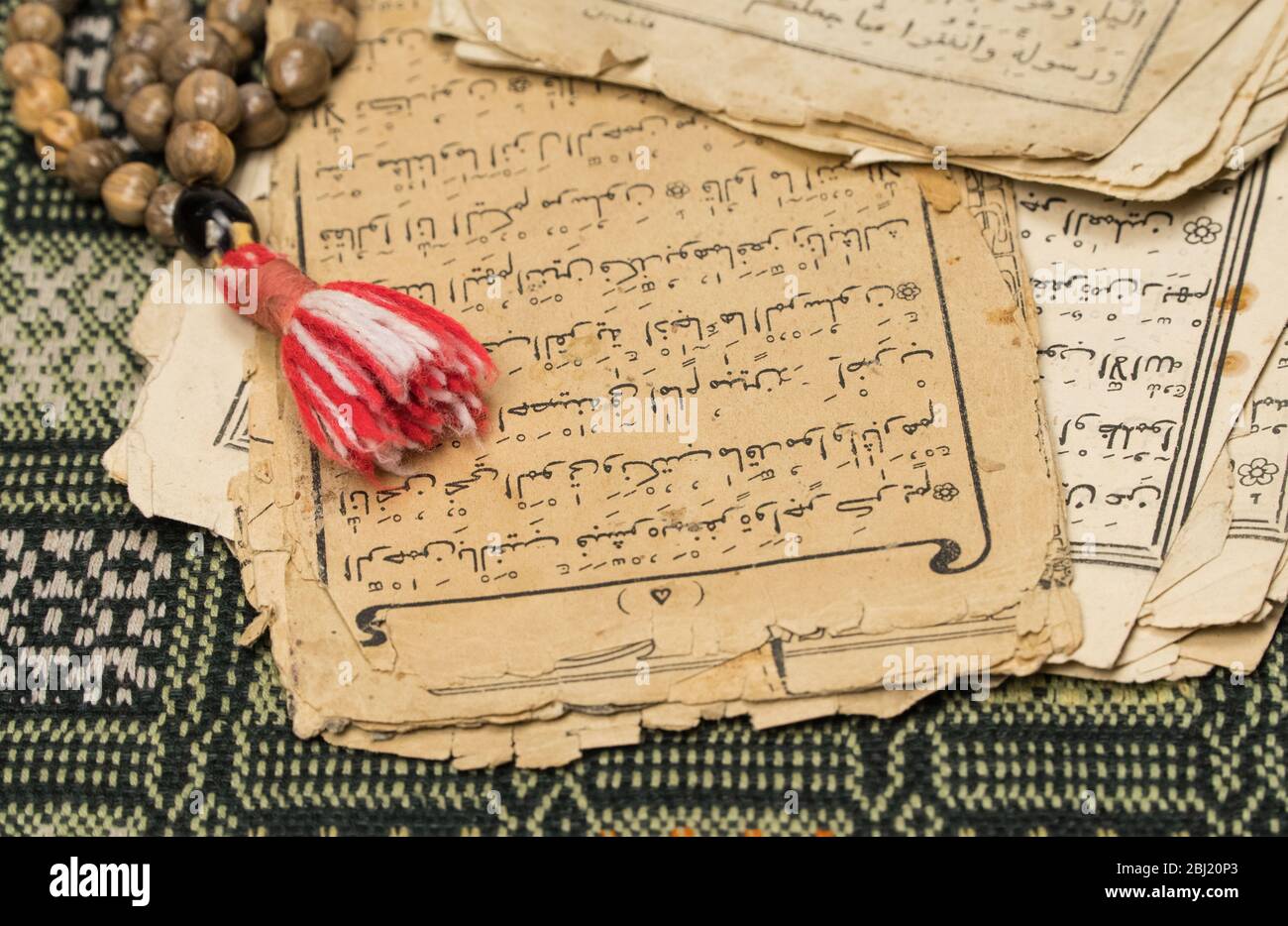 Muslim prayer beads with ancient pages from the Koran. Islamic and ...