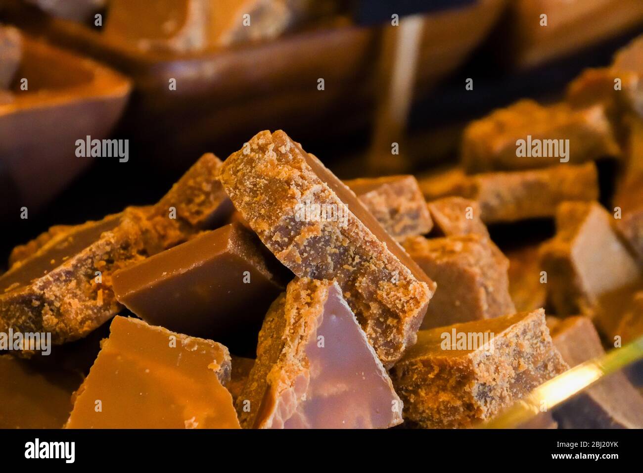 A stack of homemade caramel. Groups of caramel candy, isolated on the ...