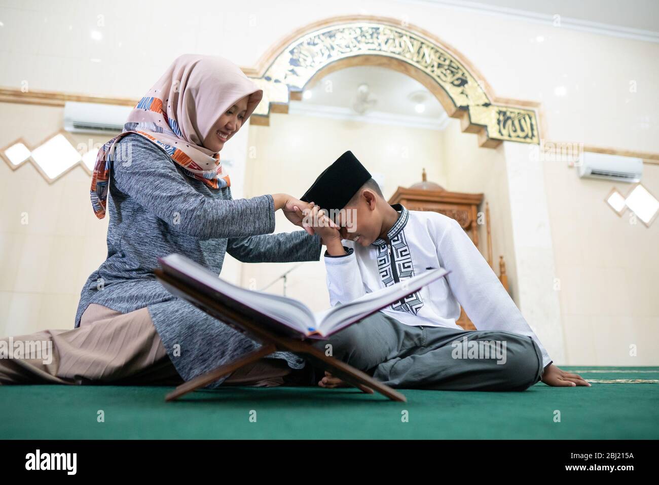 muslim kid pay respect to his teacher before studying in the mosque ...