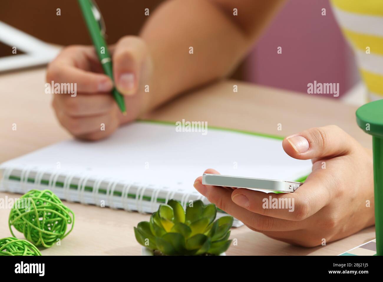 Woman write on notebook on workplace close up Stock Photo - Alamy