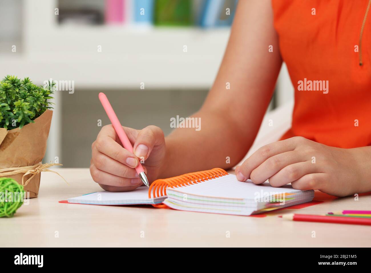 Woman write on notebook on workplace close up Stock Photo - Alamy