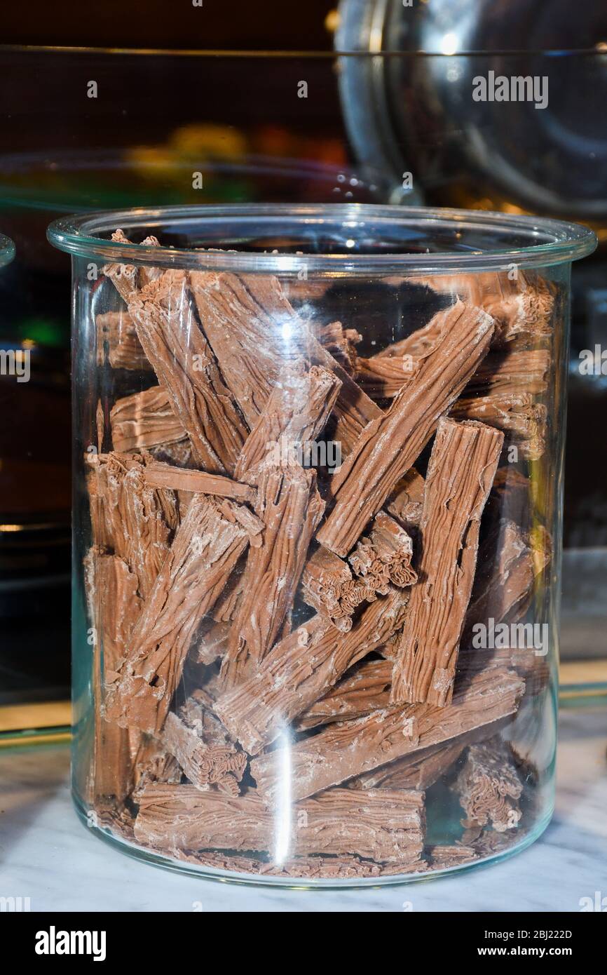 Street food dessert: waffles and pancake cones with varied toppings and fruits on top. Fresh ...